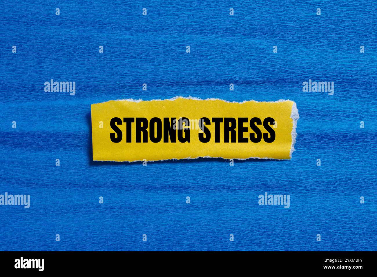Strong stress message written on ripped torn yellow paper piece with ...