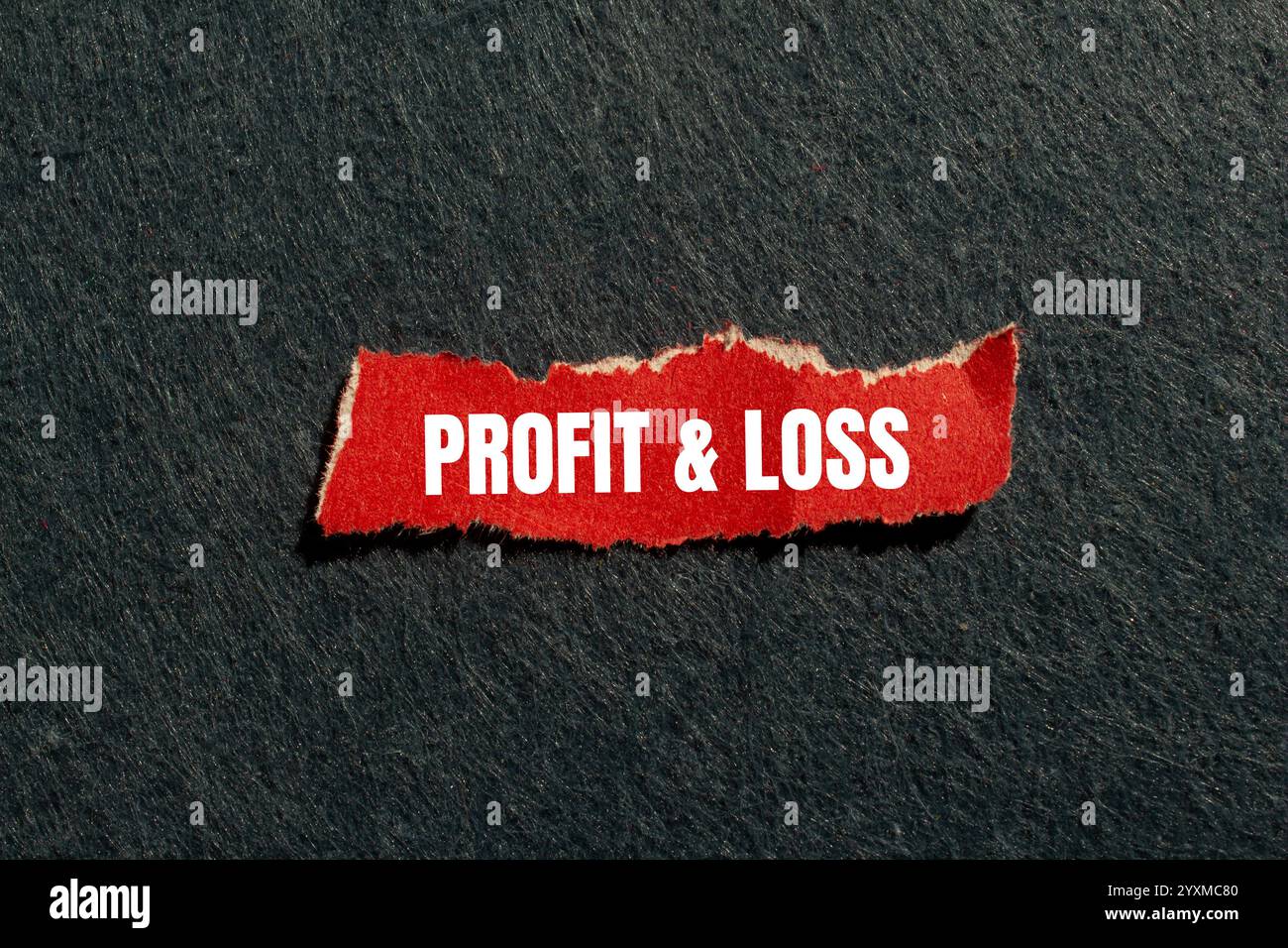 Profit and loss message written on ripped torn red paper piece with ...