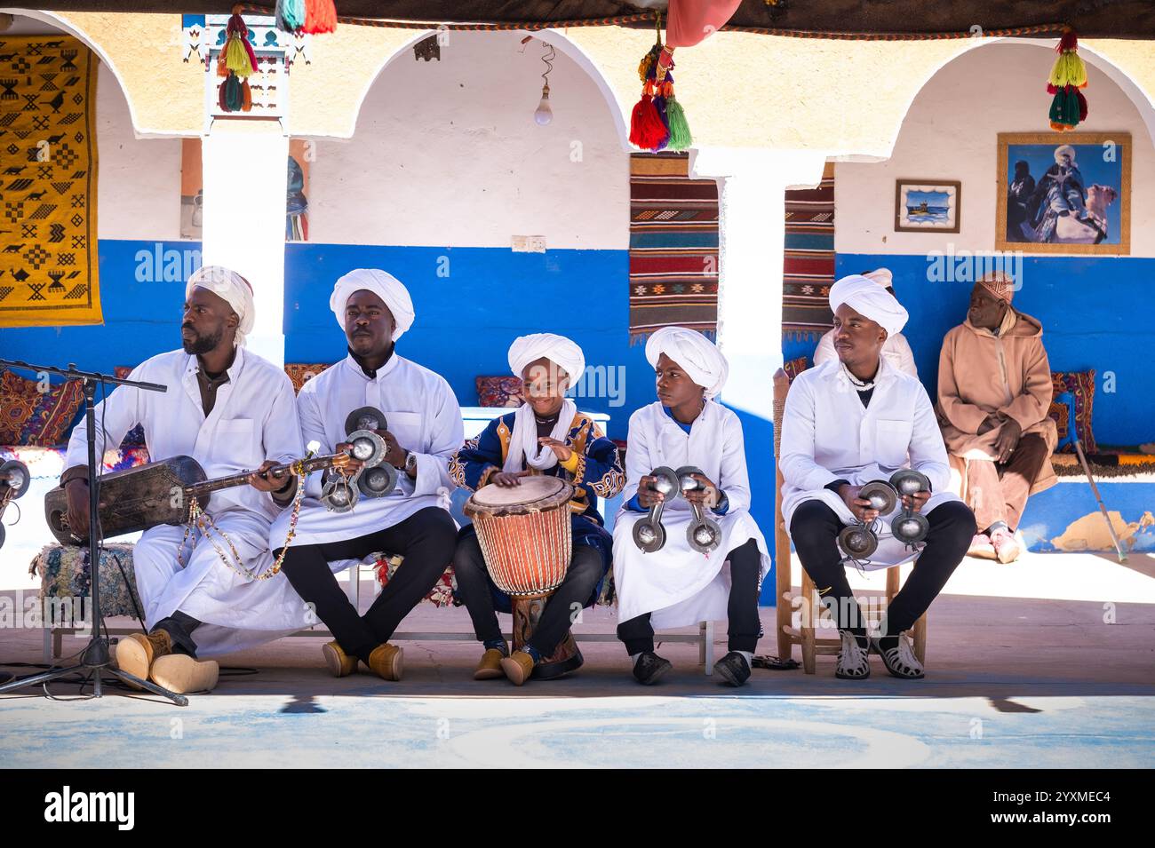 A group of five Moroccan musicians play gnawa music with a guembri or ...