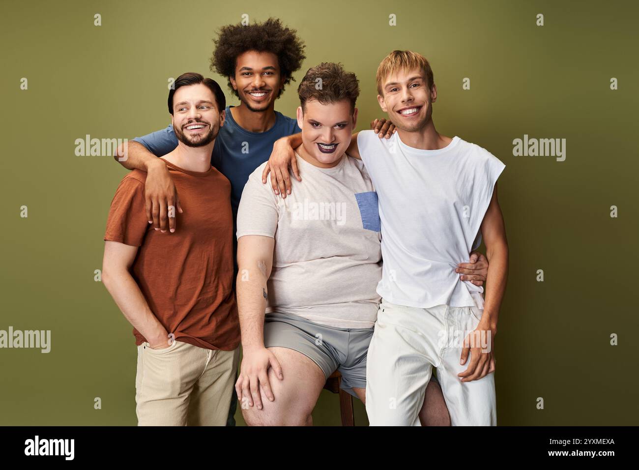 Four diverse individuals joyfully pose together, showcasing pride and ...