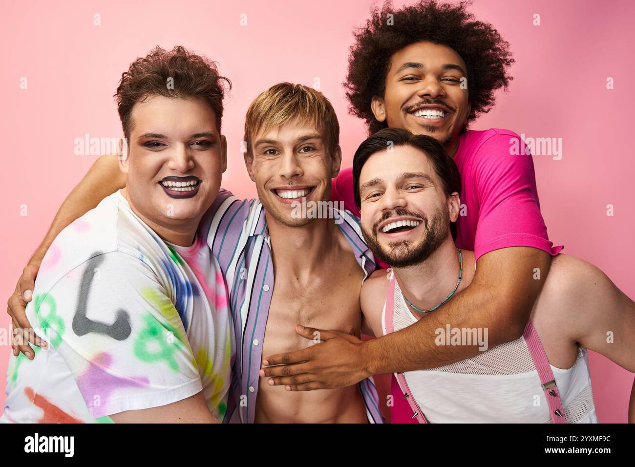 A group of four joyful friends embraces each other, showcasing their ...