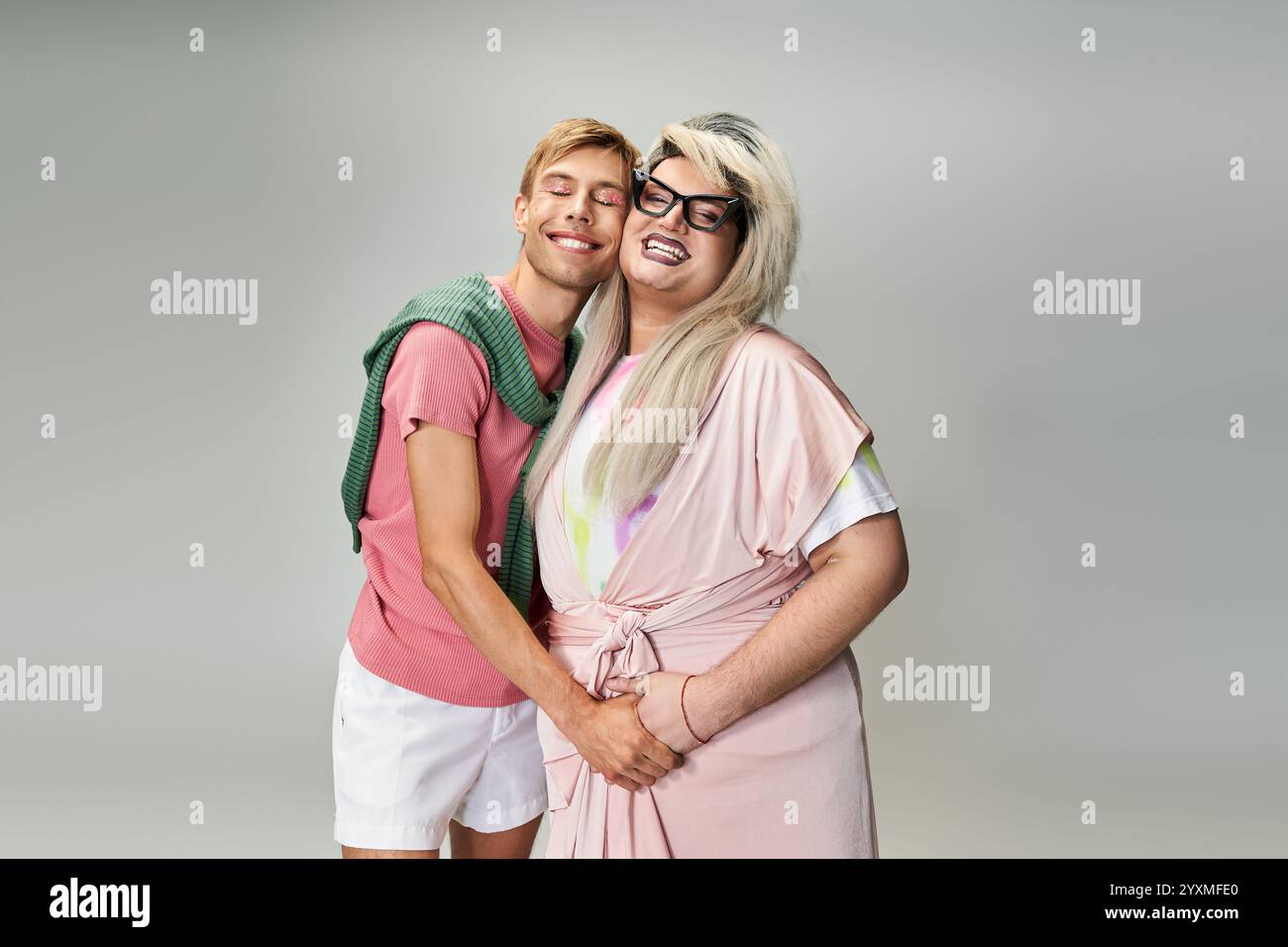 Two friends embrace joyfully, showcasing vibrant attire and a ...