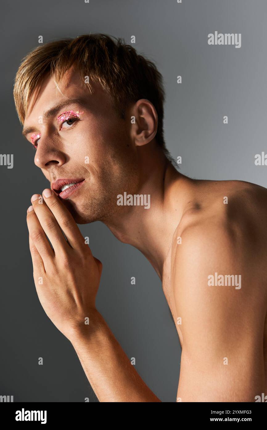 A person flaunts vibrant makeup and a confident pose, celebrating queer ...
