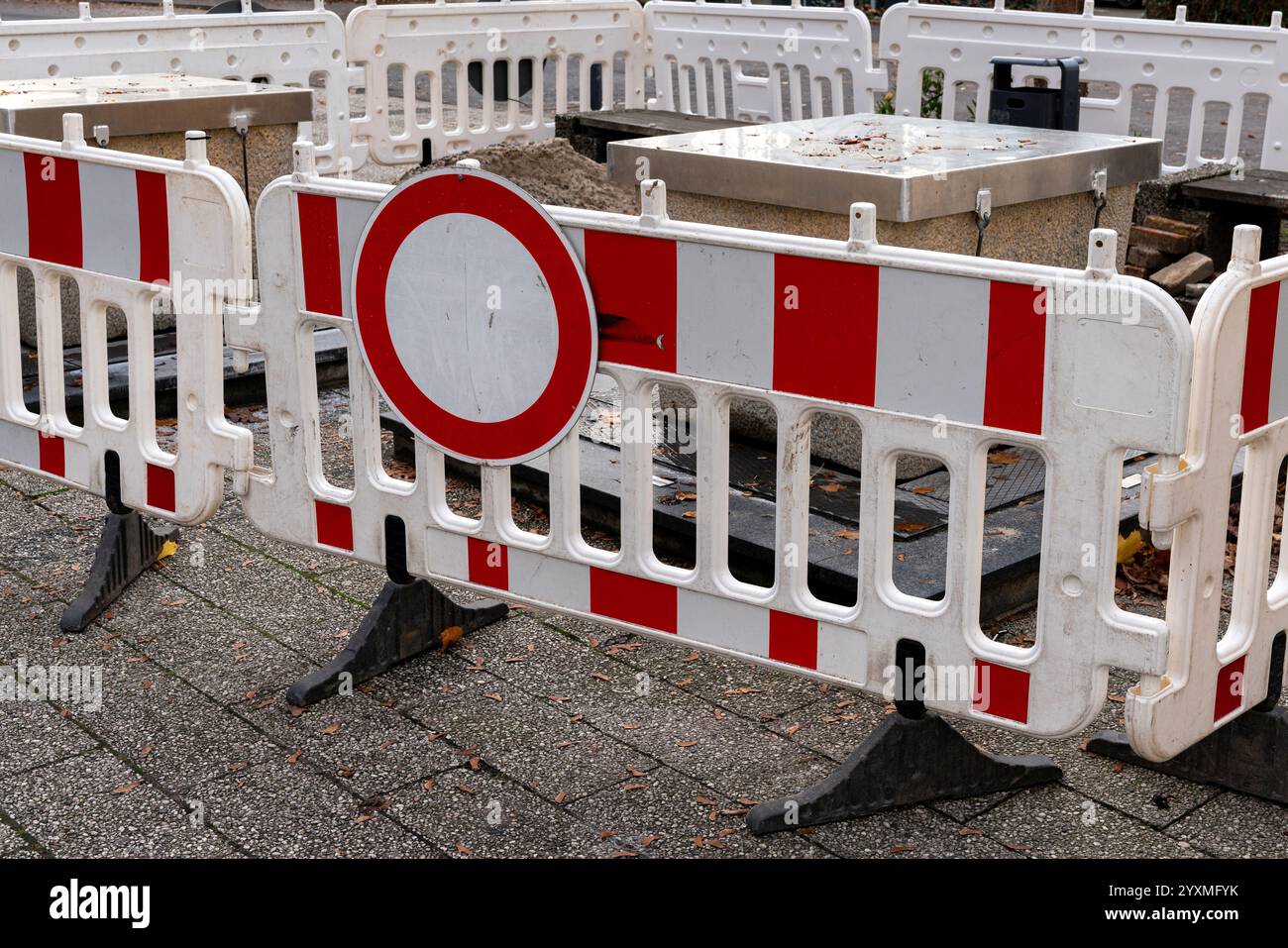 Red and white barriers restrict access to a construction site in an ...