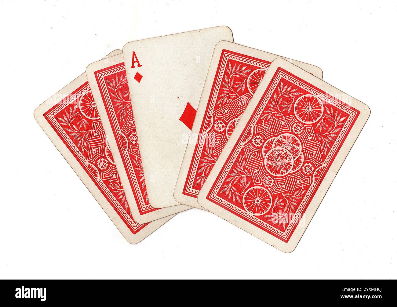 A hand of vintage playing card backs with the ace of diamonds revealed ...