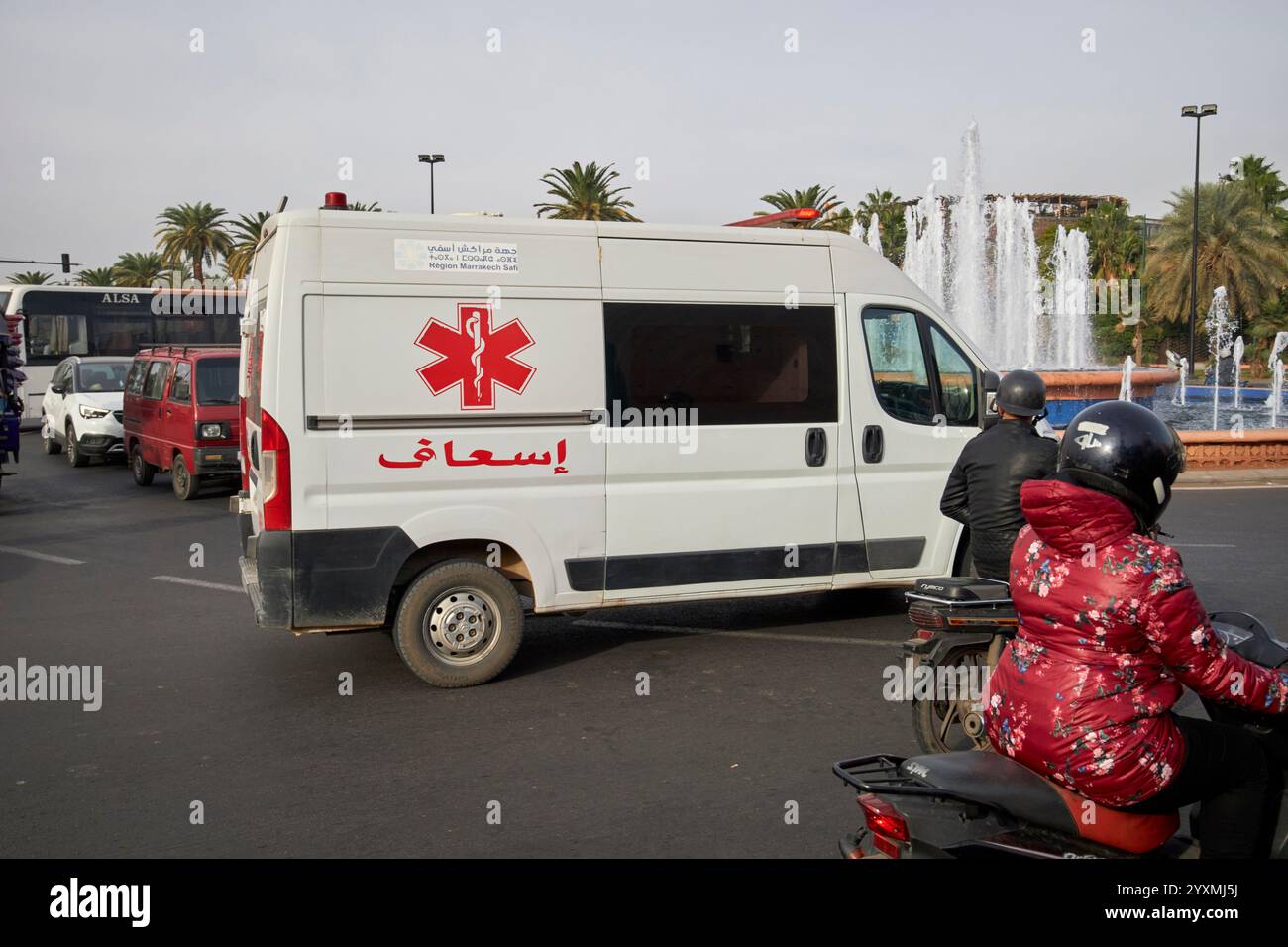emergency first aid ambulance weaving through the traffic in downtown ...
