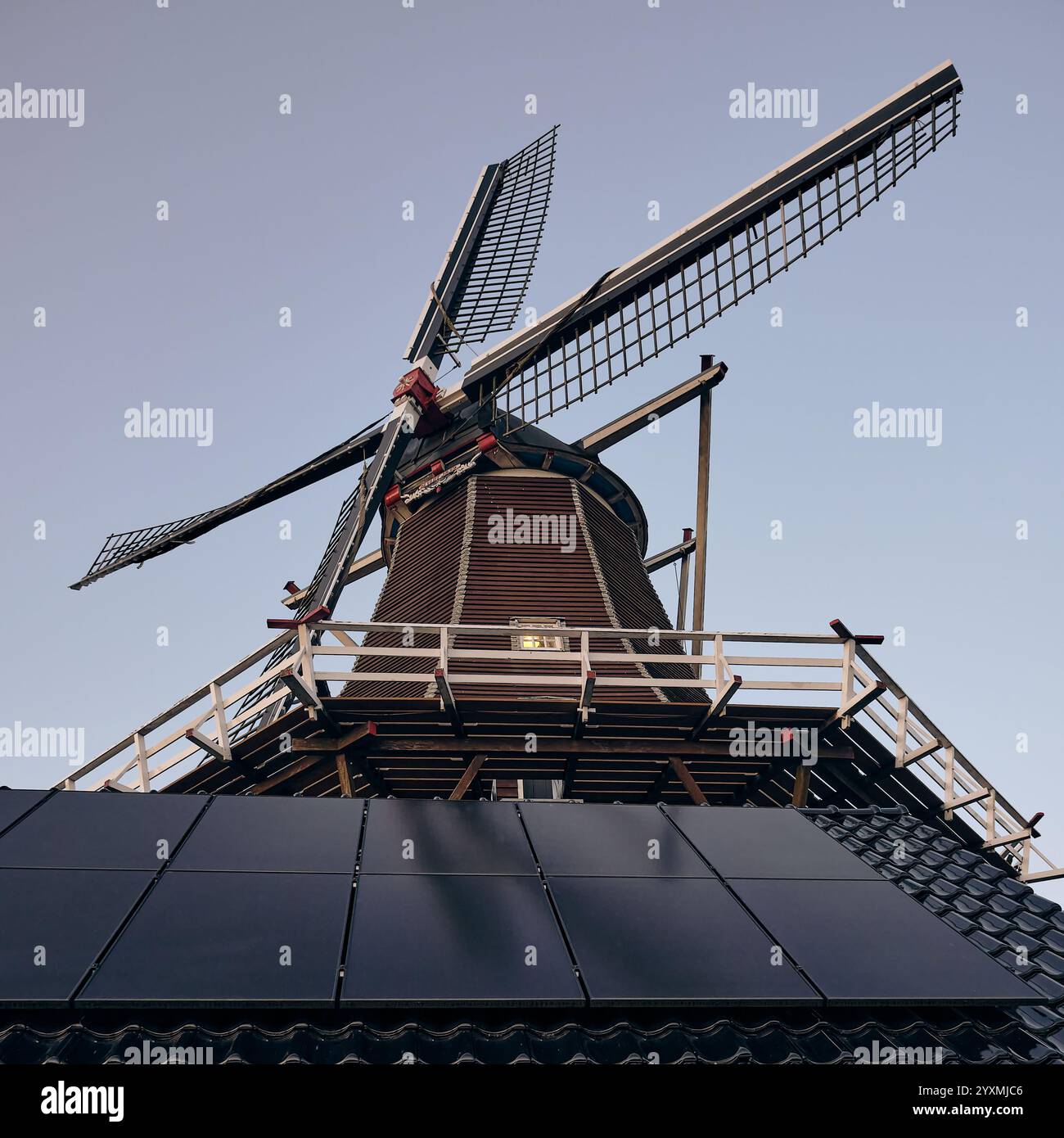 A Dutch windmill combined with solar panels on a tiled roof ...