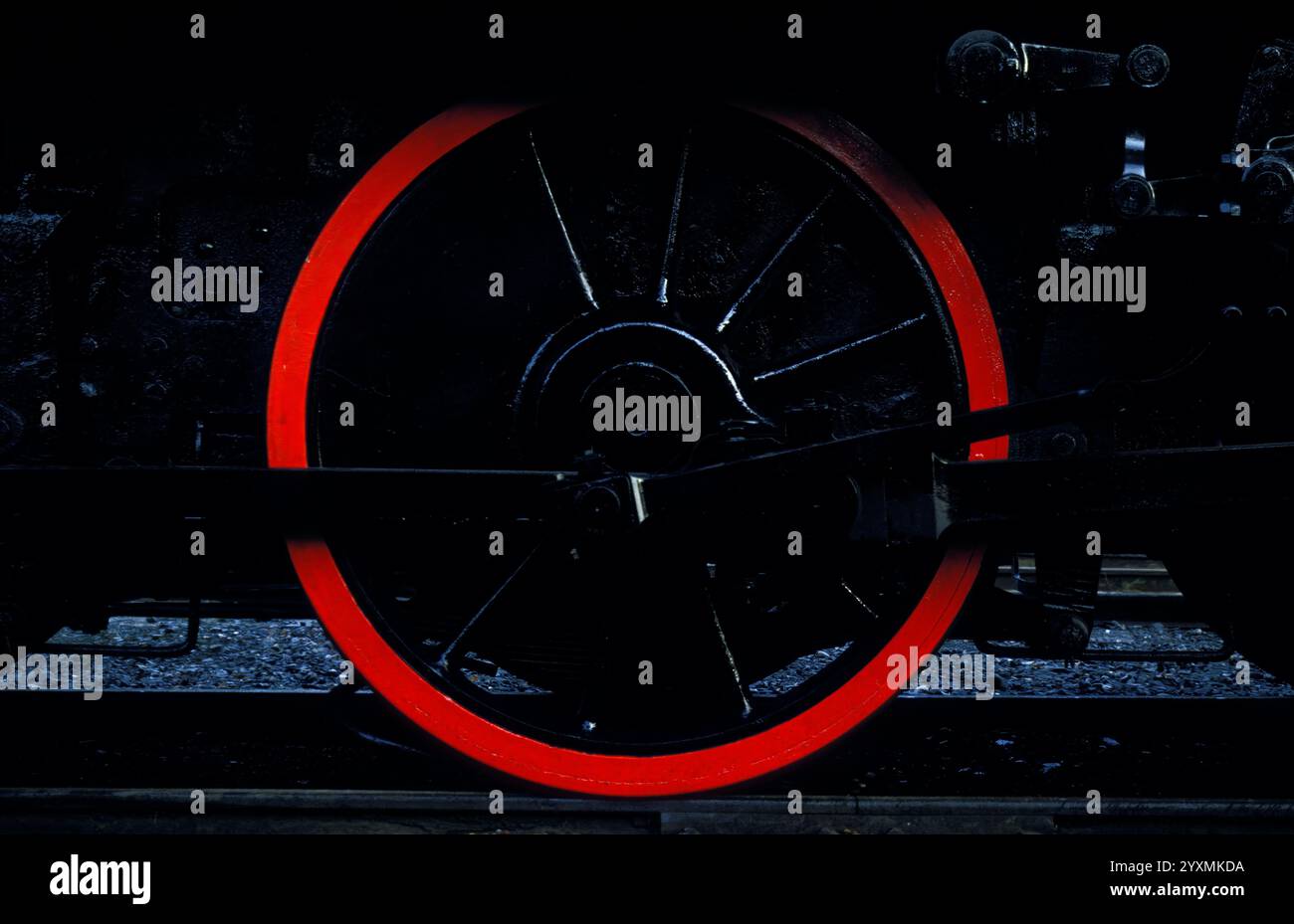 Red ring of steel on an old steam locomotive. Black painted parts of ...