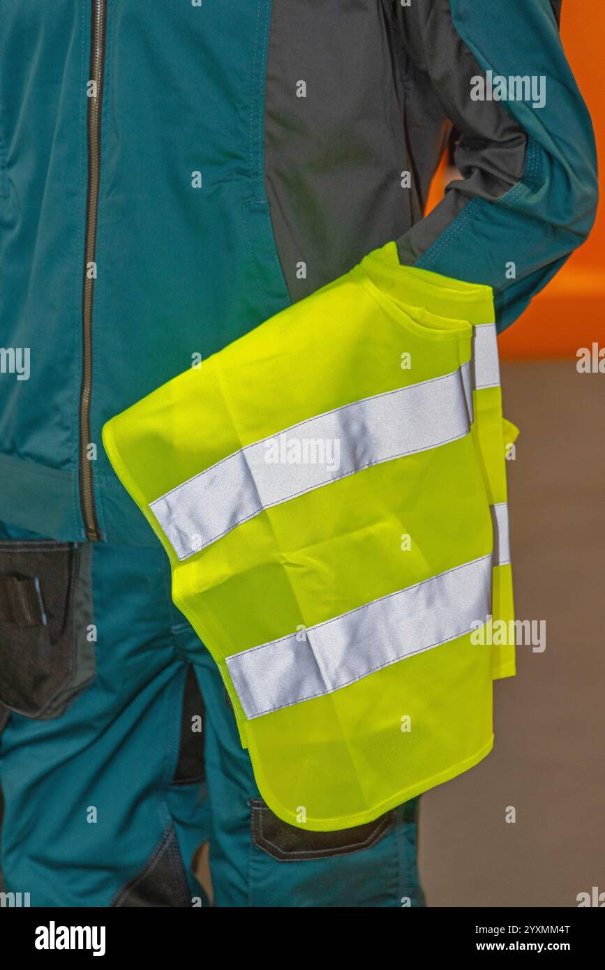 Folded Hi Vis Vest Safety Gear Holding in Hand Stock Photo - Alamy