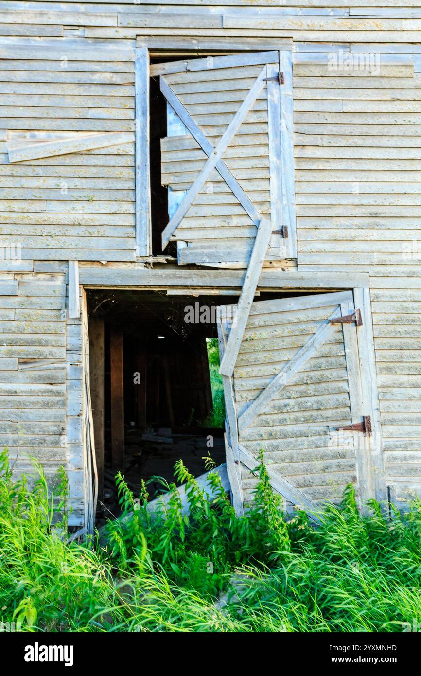 The old wooden building has two doors, one of which is open. The other ...