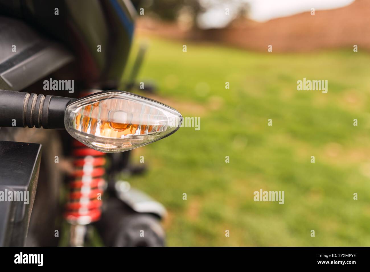 Black motorcycle rear turn signals on a sunny day with a cloudy sky ...
