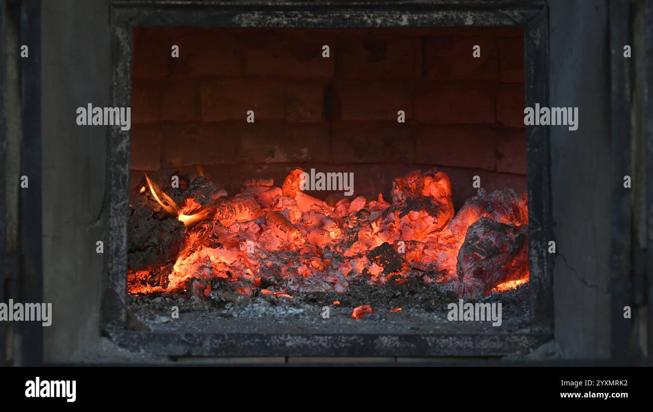 Burning wood and ashes without flame inside an old brick oven in ...