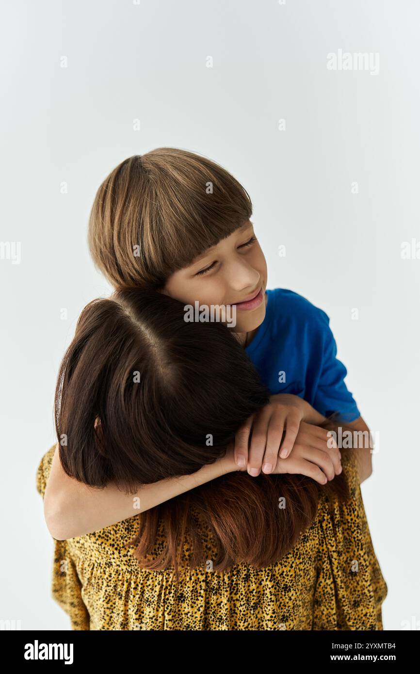 In a modern studio setting, a young mother shares a warm hug with her ...