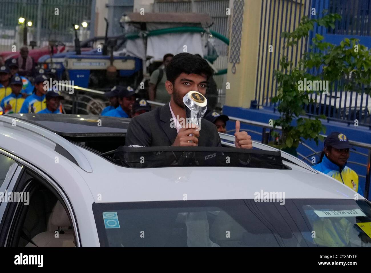 Gukesh Dommaraju poses with trophy during a procession held to honor ...