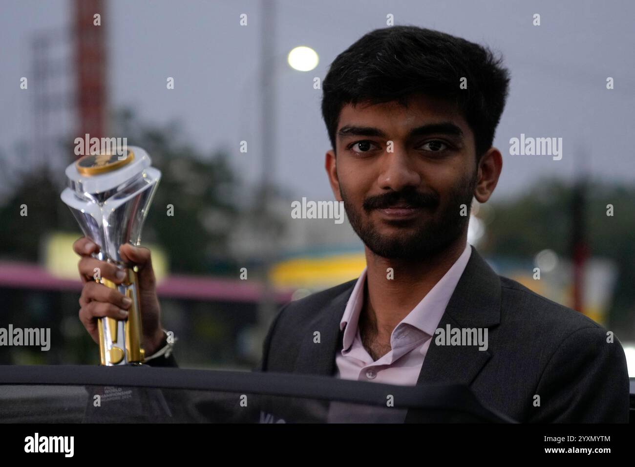 Gukesh Dommaraju poses with a trophy during a procession held to honor ...