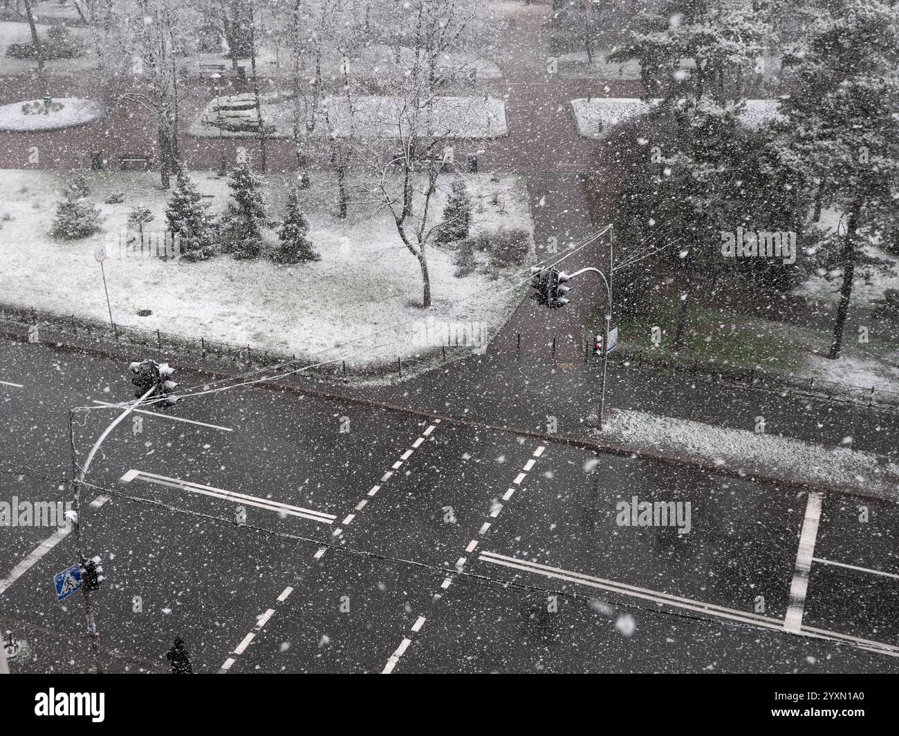 View from the window over heavy fluffy snow falling over the pedestrian ...