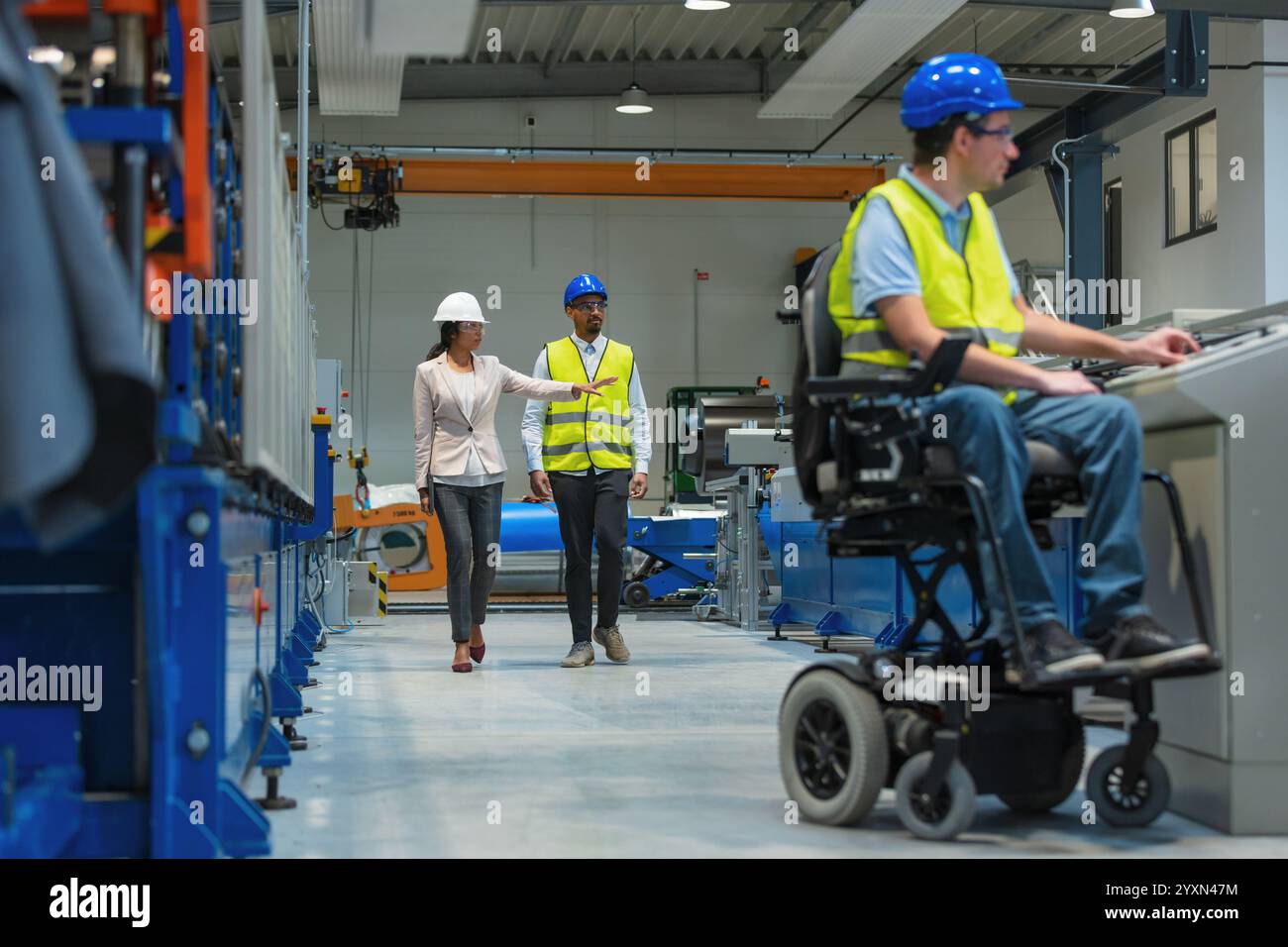 Factory woman CEO touring with an employee the production line, where ...