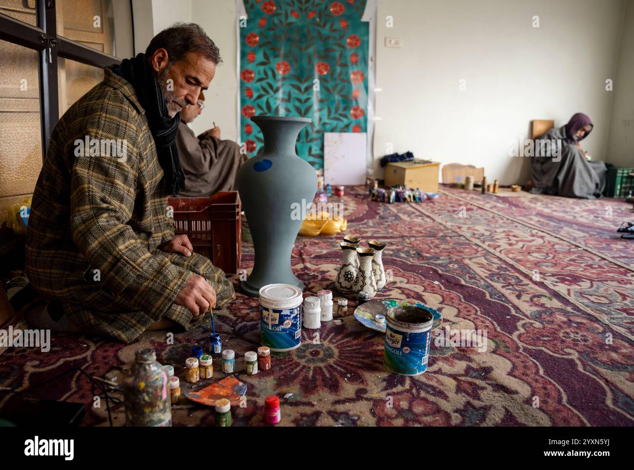 An Artisans seen working on paper-mache items at his workplace ahead of ...