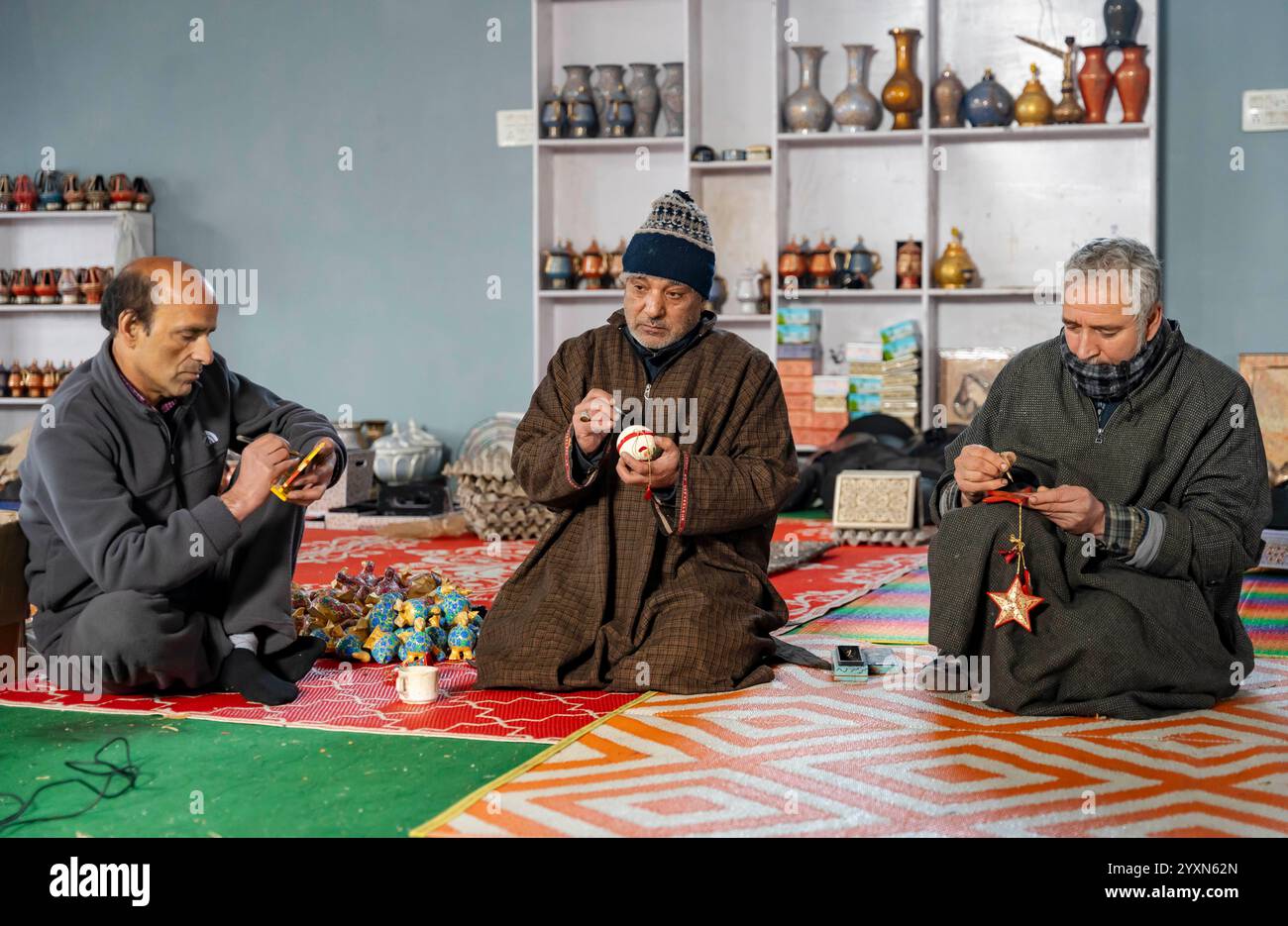 Artisans work on decorative paper-mache items at their workplace ahead ...