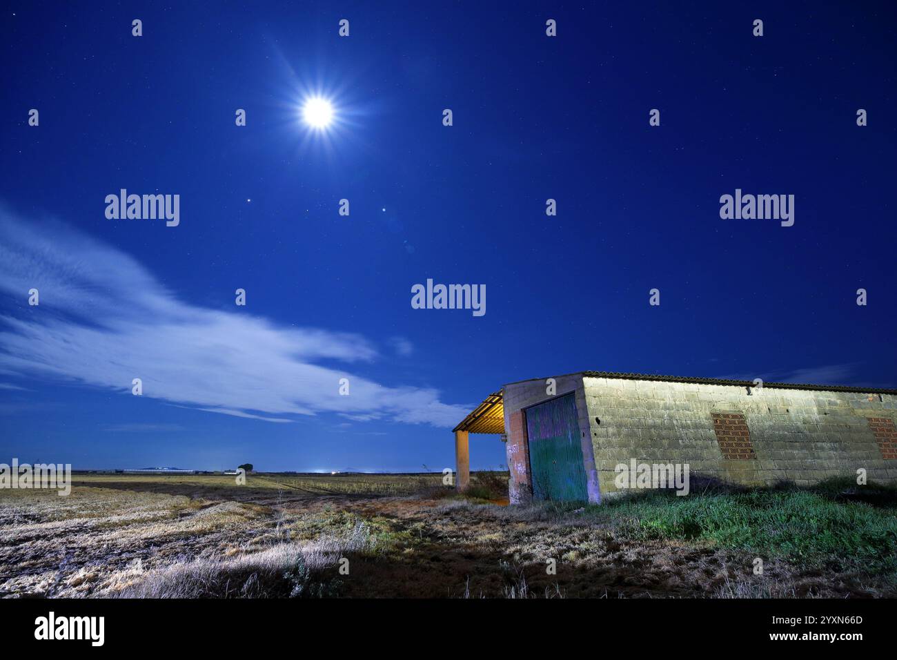 Night view of a farmland with a full moon where a tool shed can also be ...