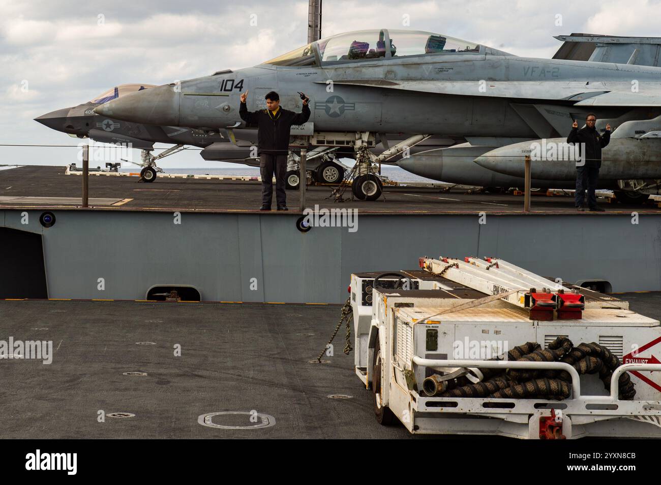 241216-N-GC571-2190 PHILIPPINE SEA (Dec. 16, 2024) – Sailors lower the ...