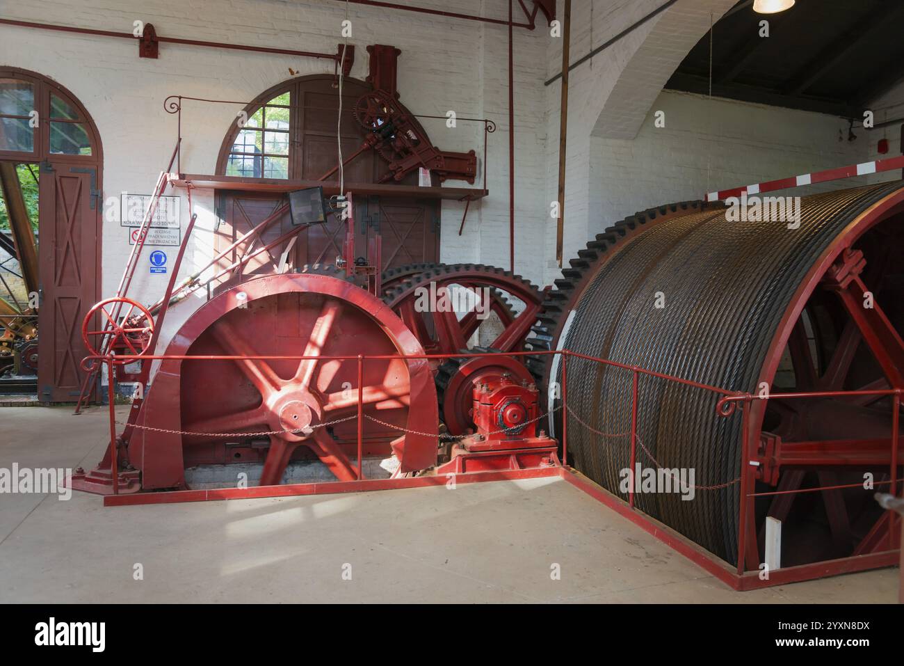 An industrial interior with large red cogwheels and technical equipment ...