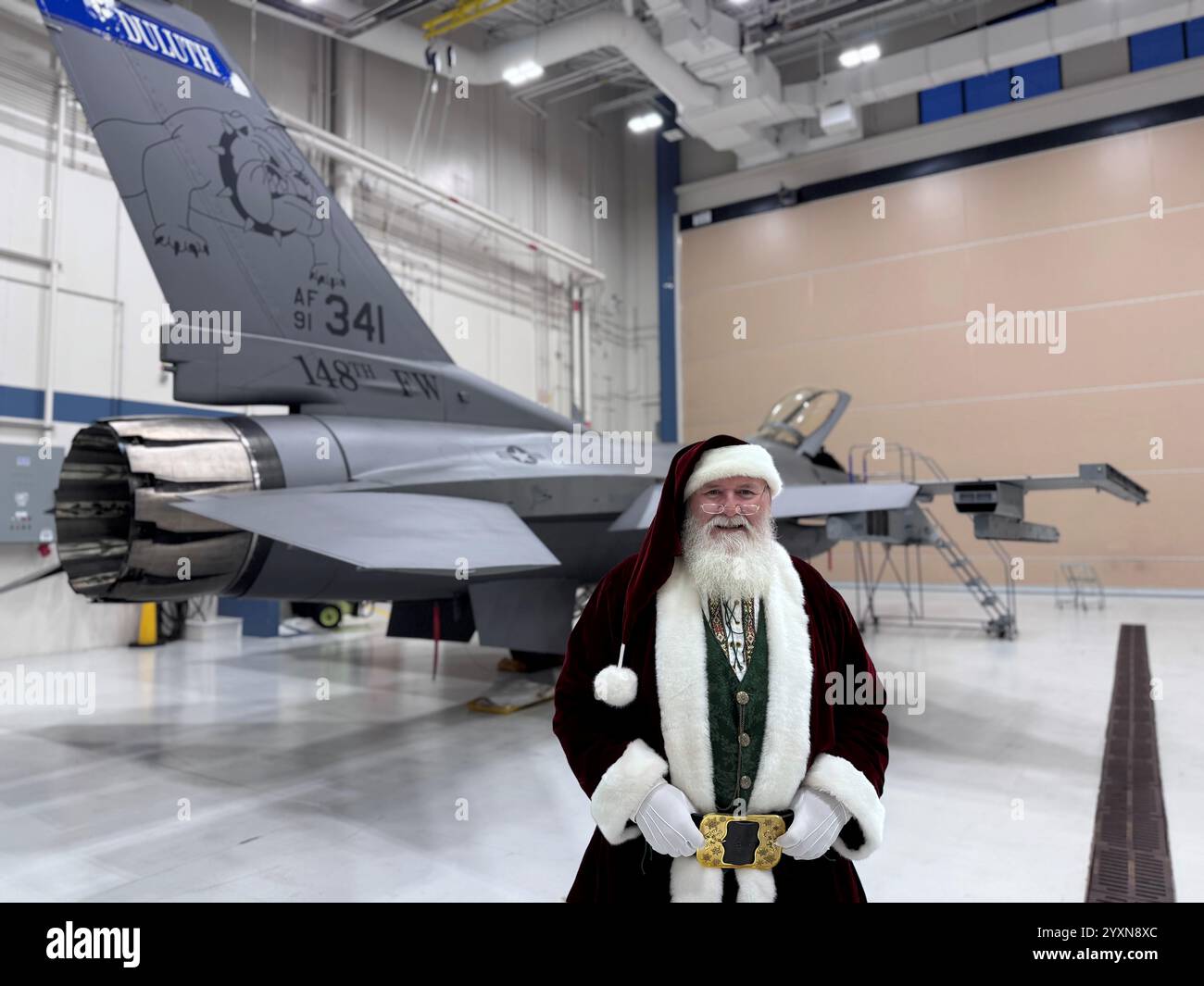 Santa Claus poses for a photo with an F-16 Fighting Falcon assigned to ...