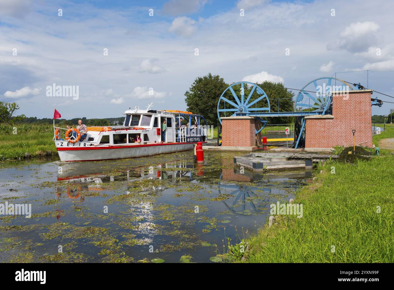 A boat passes a lock in a green landscape in sunny weather, ship Zefir ...