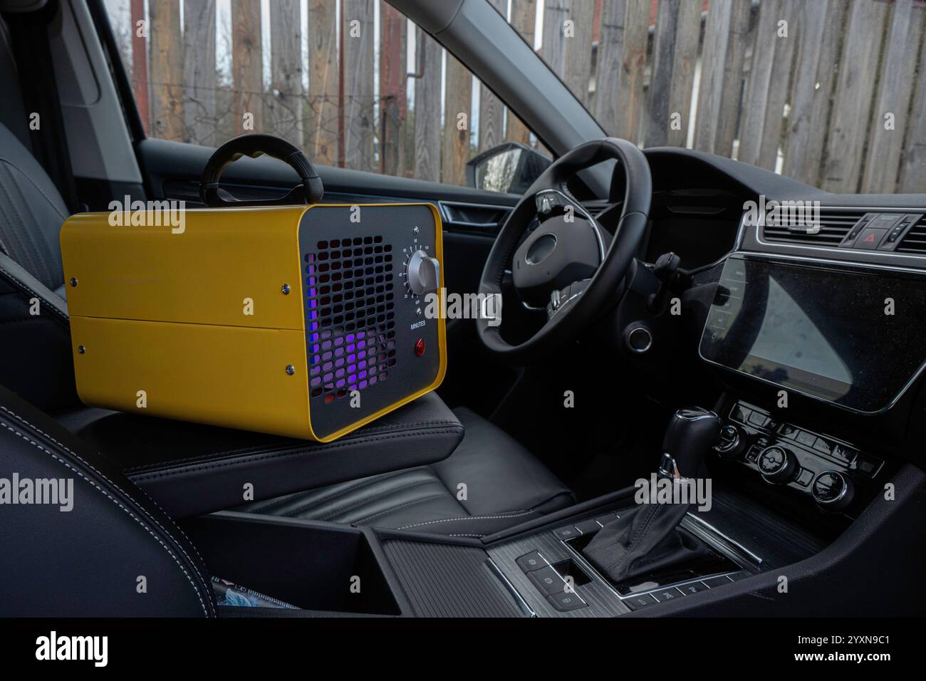ozone generator inside a car with black leather interiour Stock Photo ...