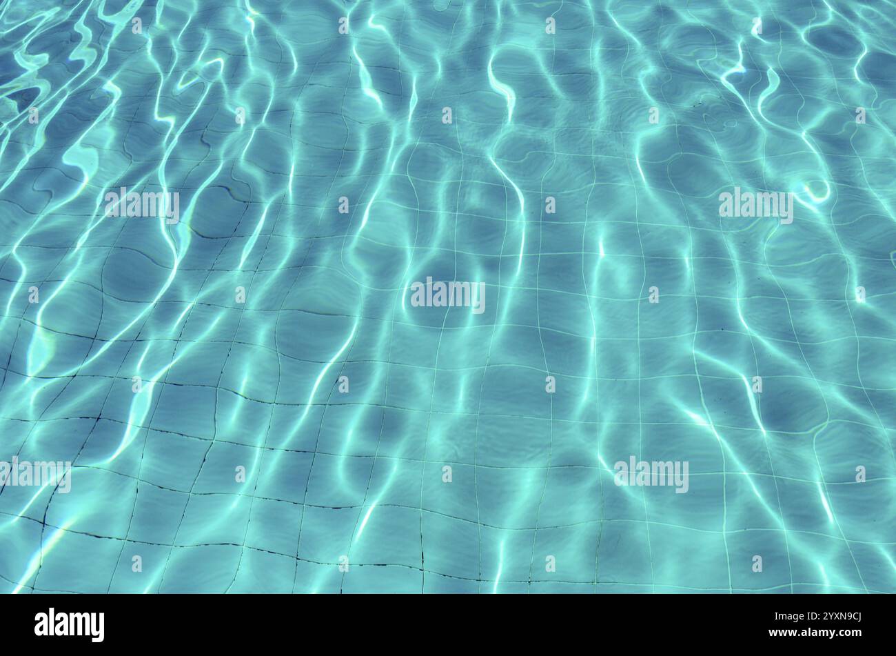 Water in pool with sun reflection. Photography reflection of sun rays on the bottom of the pool ...