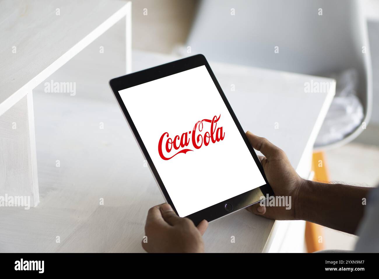 Coca-Cola logo is seen on a mobile phone and a computer screen Stock Photo - Alamy