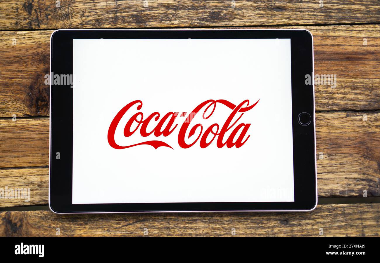 Coca-Cola logo is seen on a mobile phone and a computer screen Stock Photo - Alamy