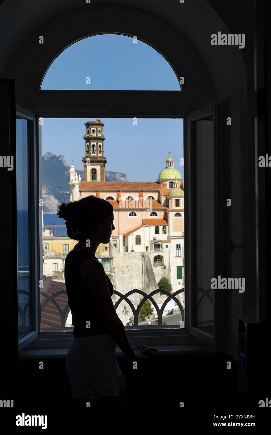 Woman in silhouette looking at the window, Atrani, Amalfi coast, Italy ...