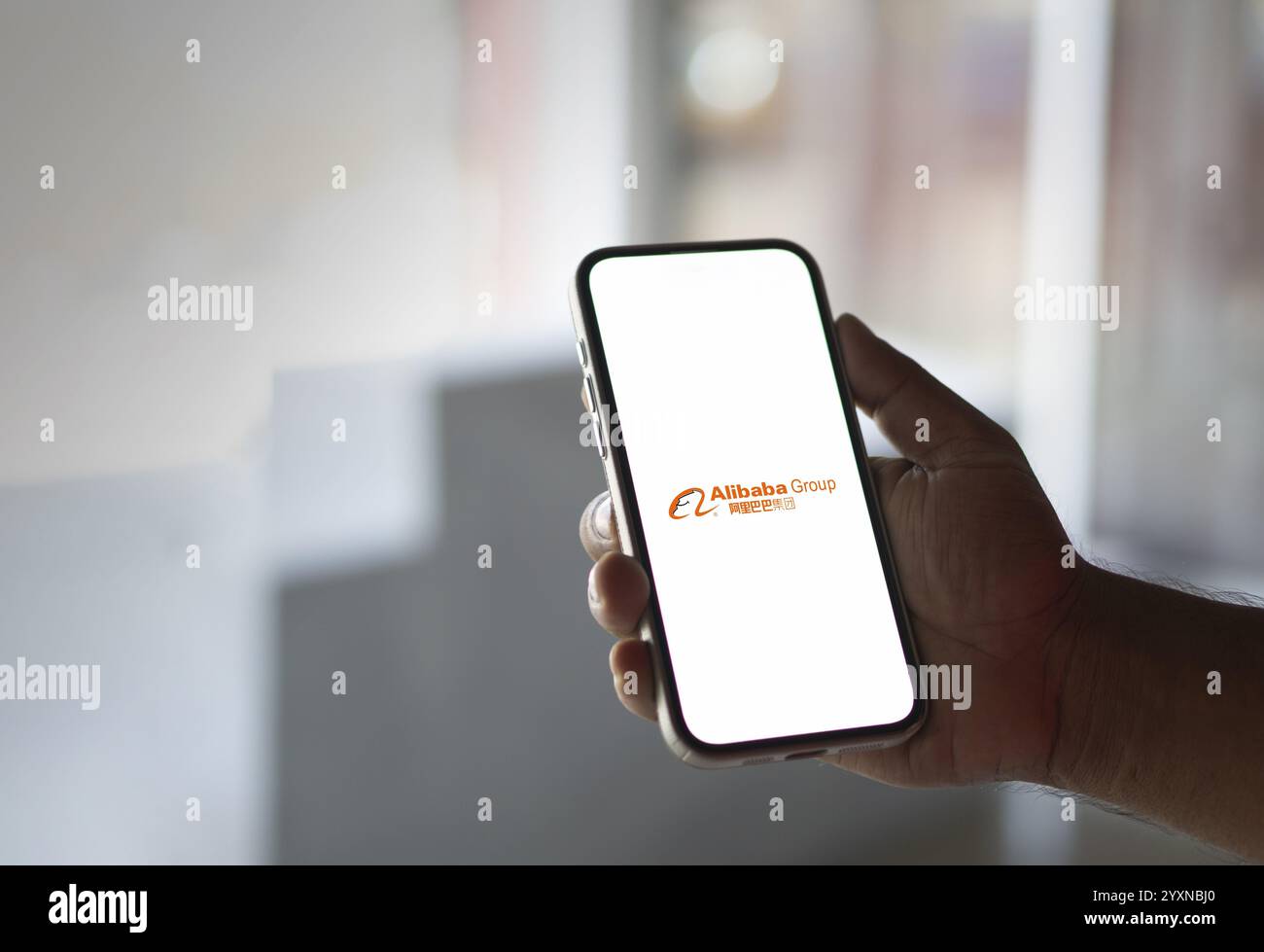 Alibaba logo on the screen smartphone. Alibaba Group Holding Limited is ...