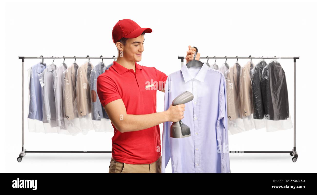 Dry cleaner ironing shirts with a hand steam iron isolated on white ...