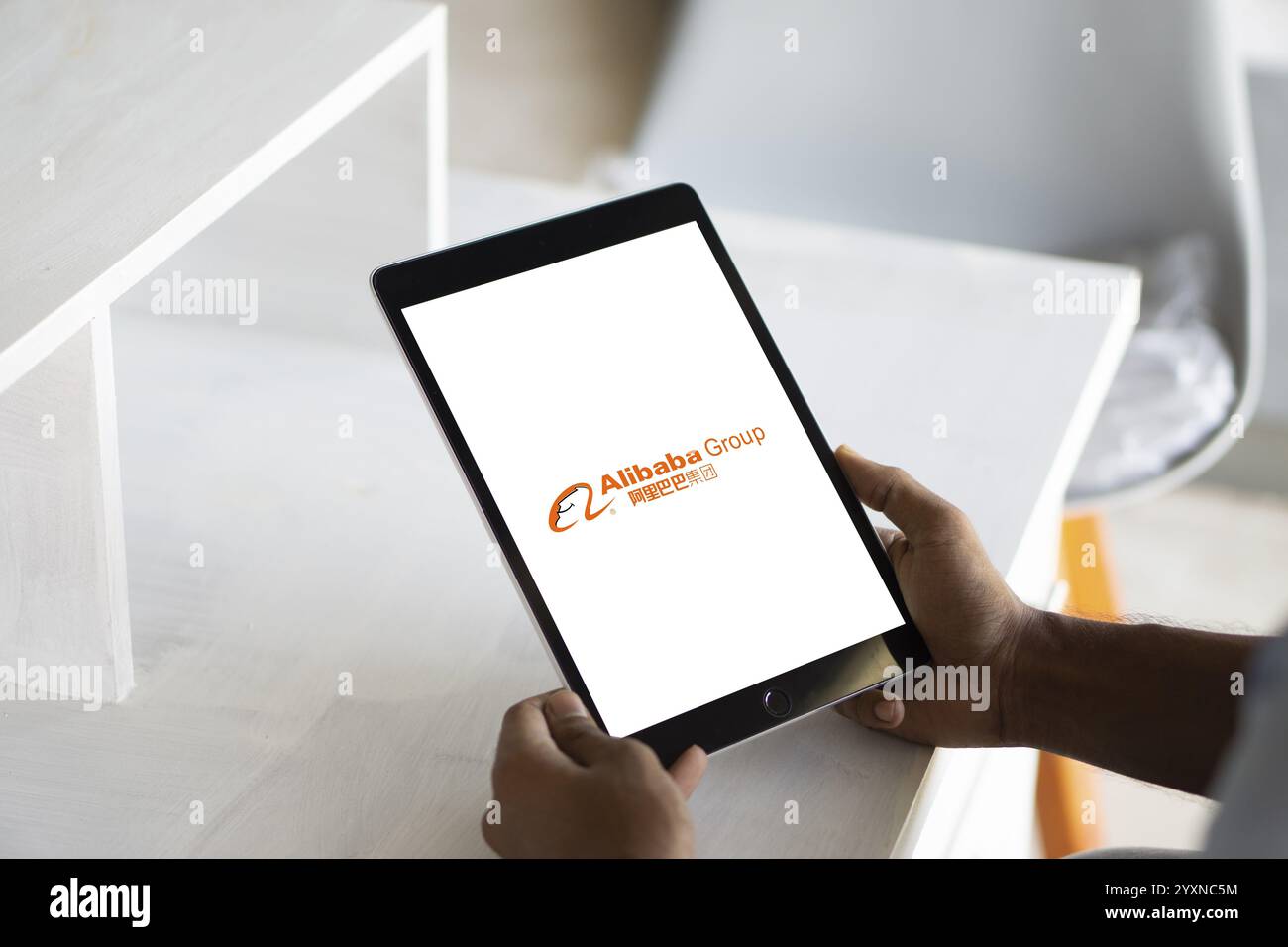 Alibaba logo on the screen smartphone. Alibaba Group Holding Limited is ...