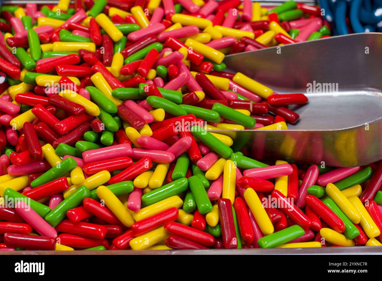 Red, pink, yellow and green candy sticks on a market stall Stock Photo ...