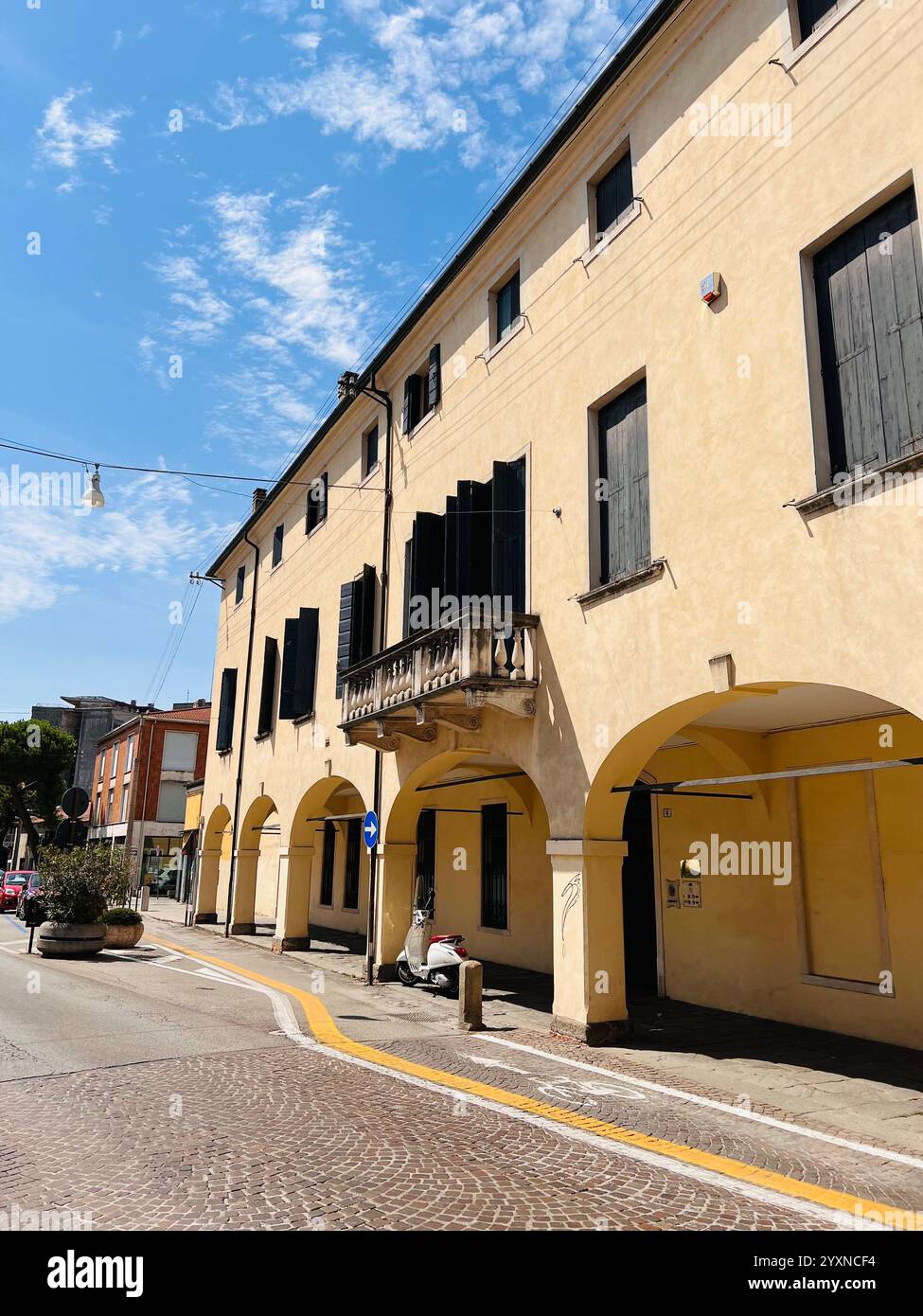 Street showcases historical European architecture with arched walkways ...