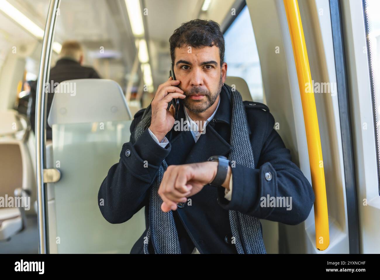 Frontal portrait of a serious caucasian adult, businessman using ...