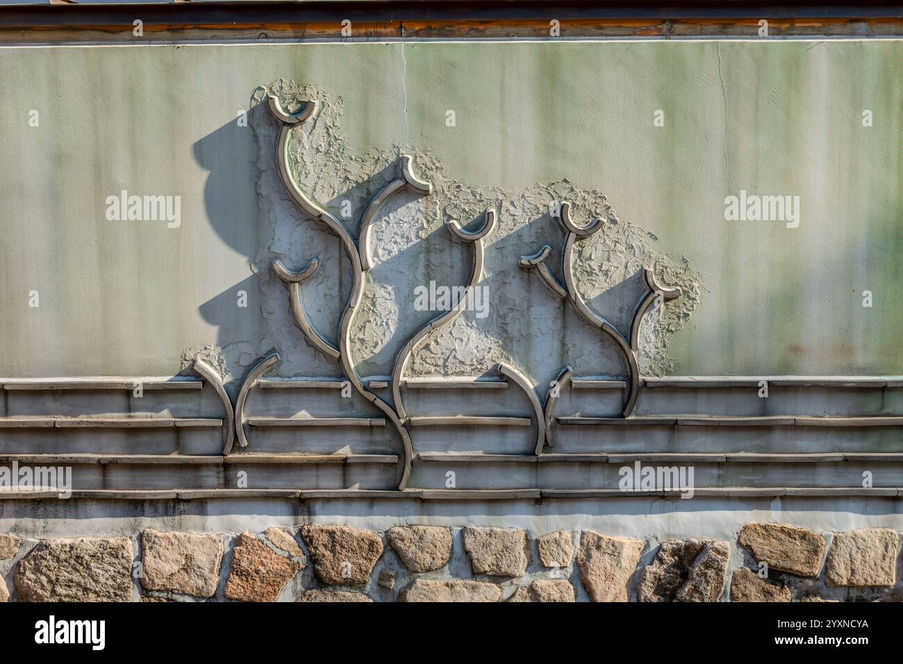 A traditional Korean wall with decorative wooden elements and tiles ...