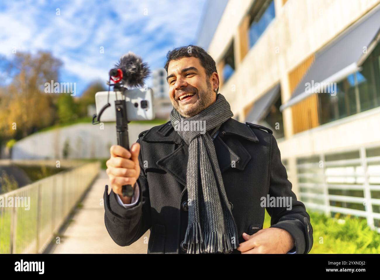 Mature elegant man vlogger smile while recording videoblog content in ...