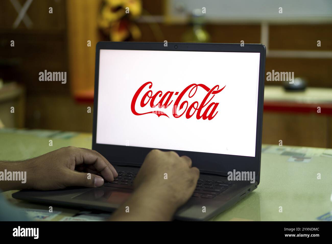 Coca-Cola logo is seen on a mobile phone and a computer screen Stock Photo - Alamy