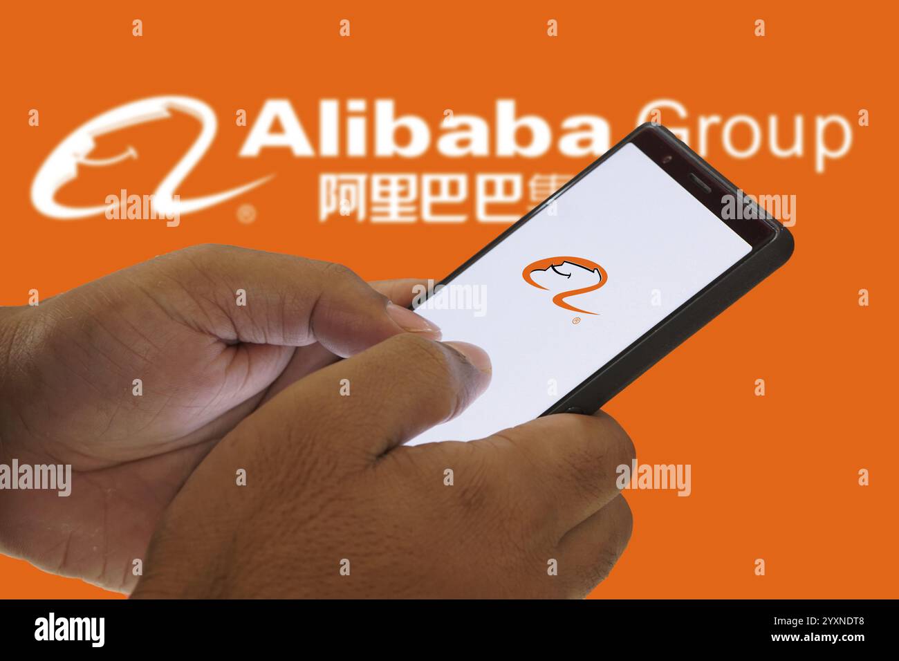 Alibaba logo on the screen smartphone. Alibaba Group Holding Limited is ...