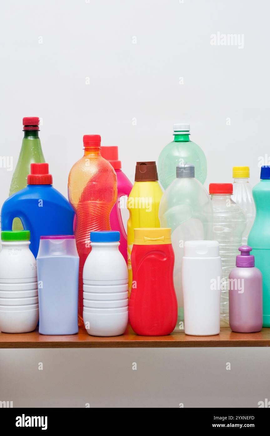 a range of empty plastic containers and bottles for recycling on shelf ...
