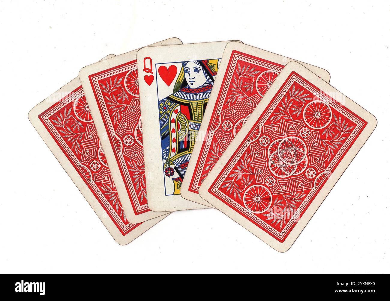 A hand of vintage playing card backs with the queen of hearts revealed ...