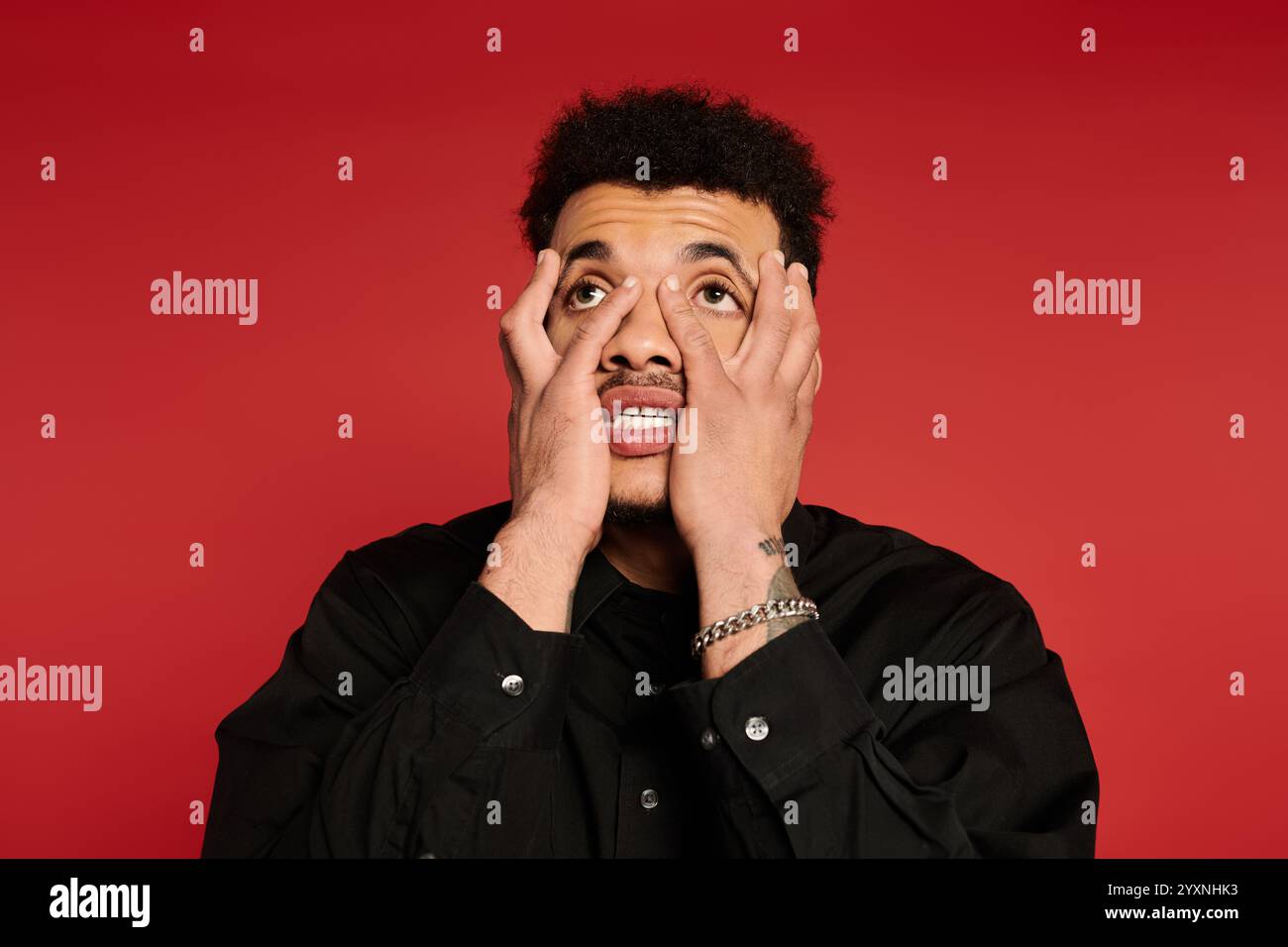 Young man shows a range of emotions while posing with a bold expression ...