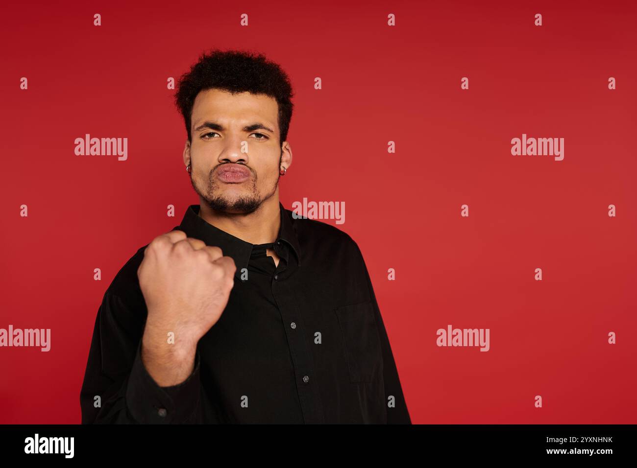 A young handsome man strikes a confident pose showing determination and ...
