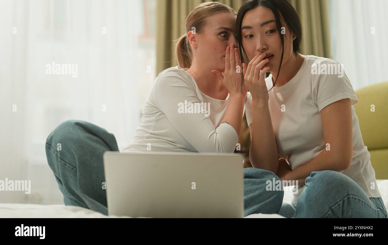 Multiracial friends women Caucasian woman whisper secret talk secrecy information gossip Asian ...
