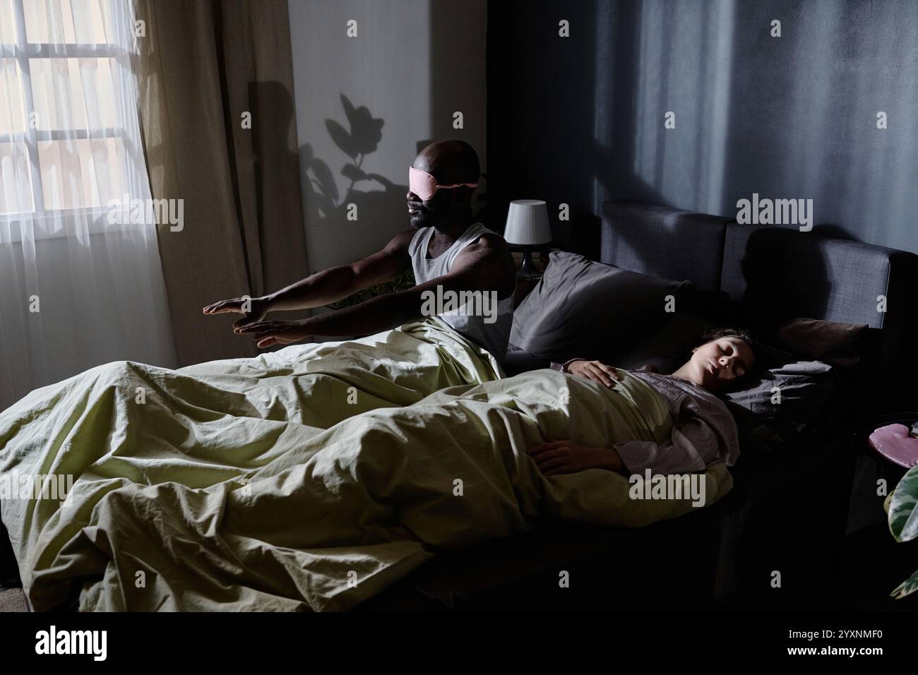 High angle shot of African American man suffering from sleepwalking ...