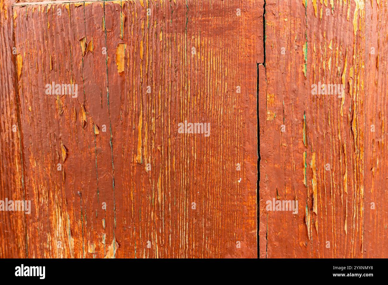 The image is of a wooden surface with a lot of rust and paint peeling ...